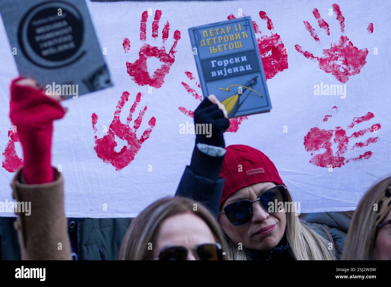People show books during protest to mark 100 days since the collapse of ...
