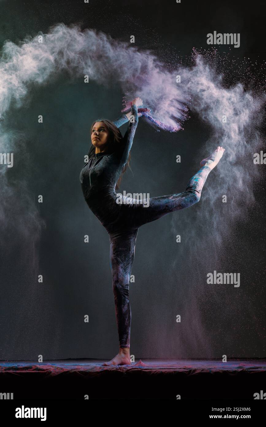 Dynamic female dancer in motion, surrounded by vibrant pink powder explosion, expressing energy ...