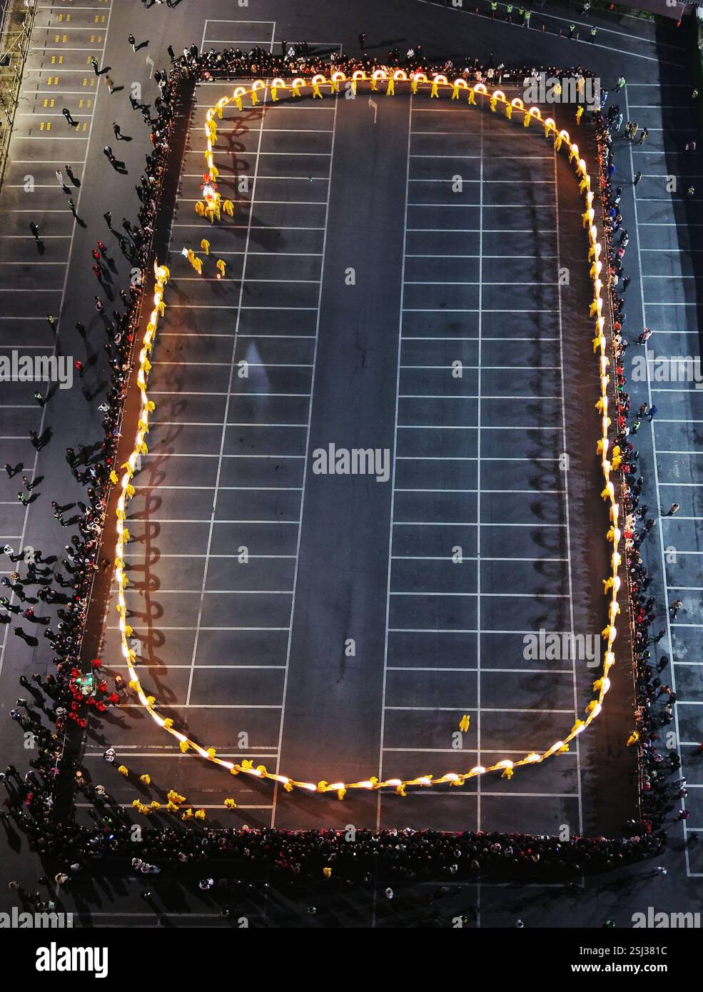 HANGZHOU, CHINA - FEBRUARY 11, 2025 - Tourists watch a dragon parade ...