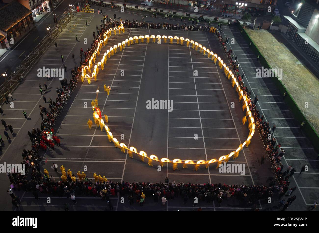 HANGZHOU, CHINA - FEBRUARY 11, 2025 - Tourists watch a dragon parade ...
