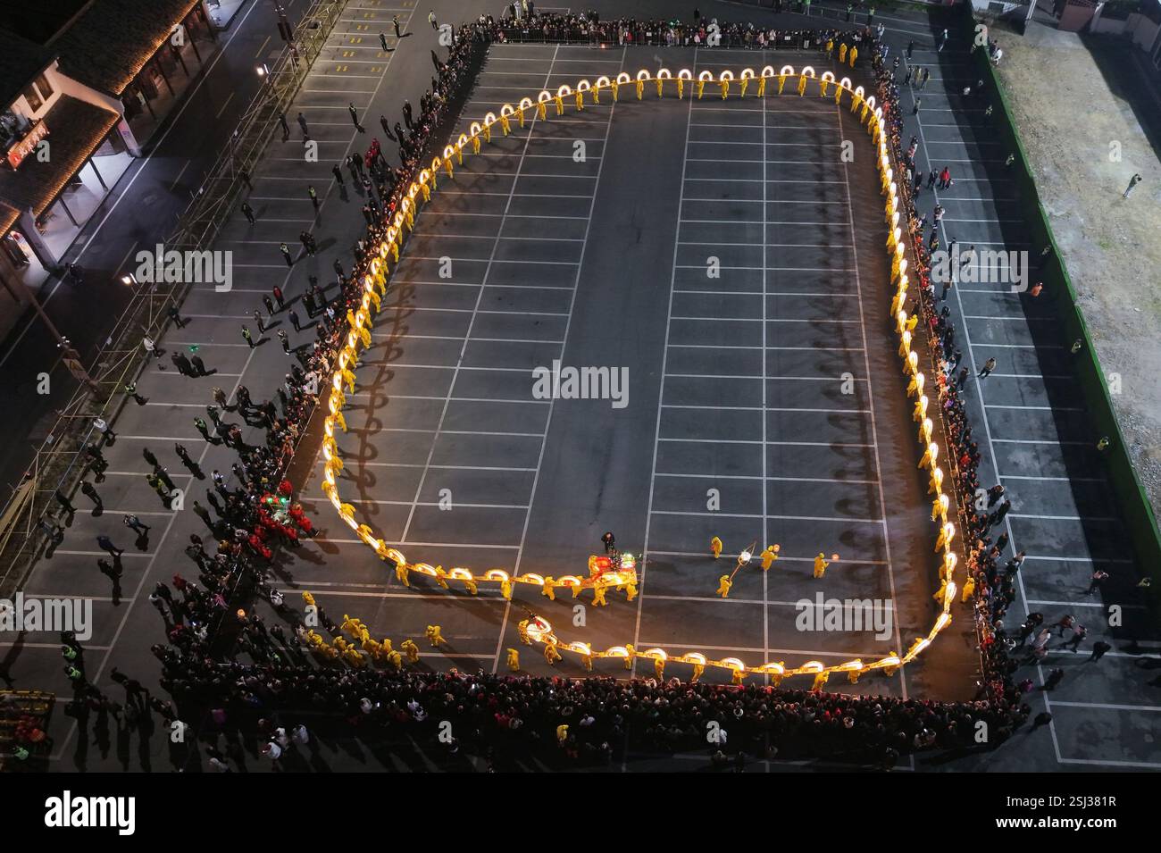 HANGZHOU, CHINA - FEBRUARY 11, 2025 - Tourists watch a dragon parade ...
