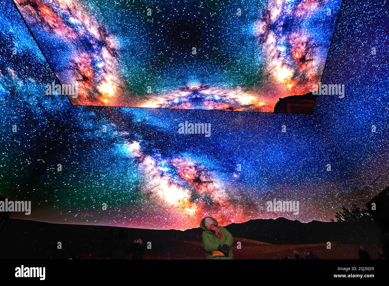 A visitor views a display at the free public galleries at Outernet ...