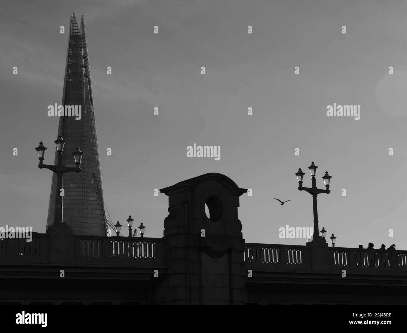Pedestrians cross Southwark Bridge over the River Thames, London, as a ...