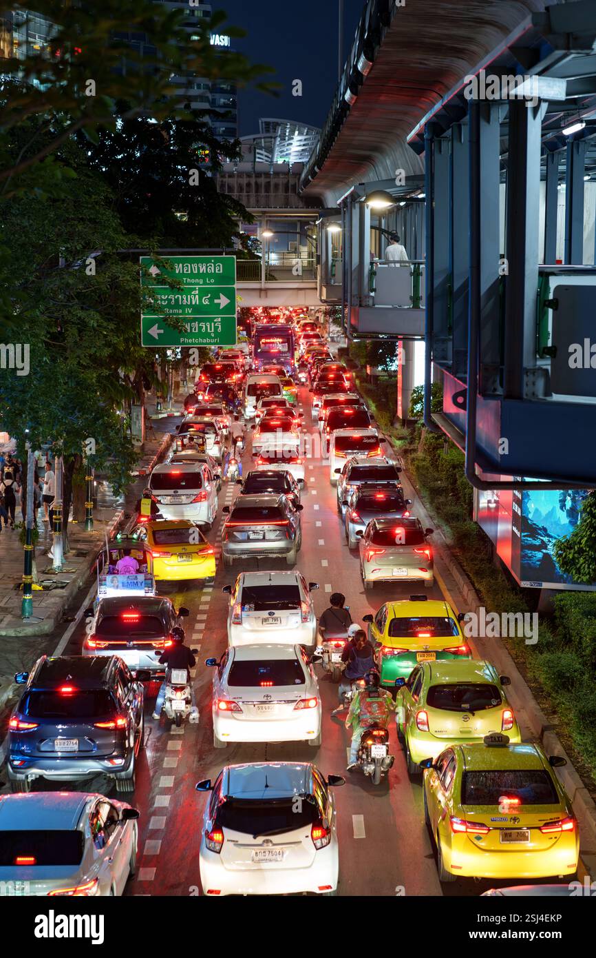 A bustling night scene on Sukhumvit Road in Bangkok captures the ...