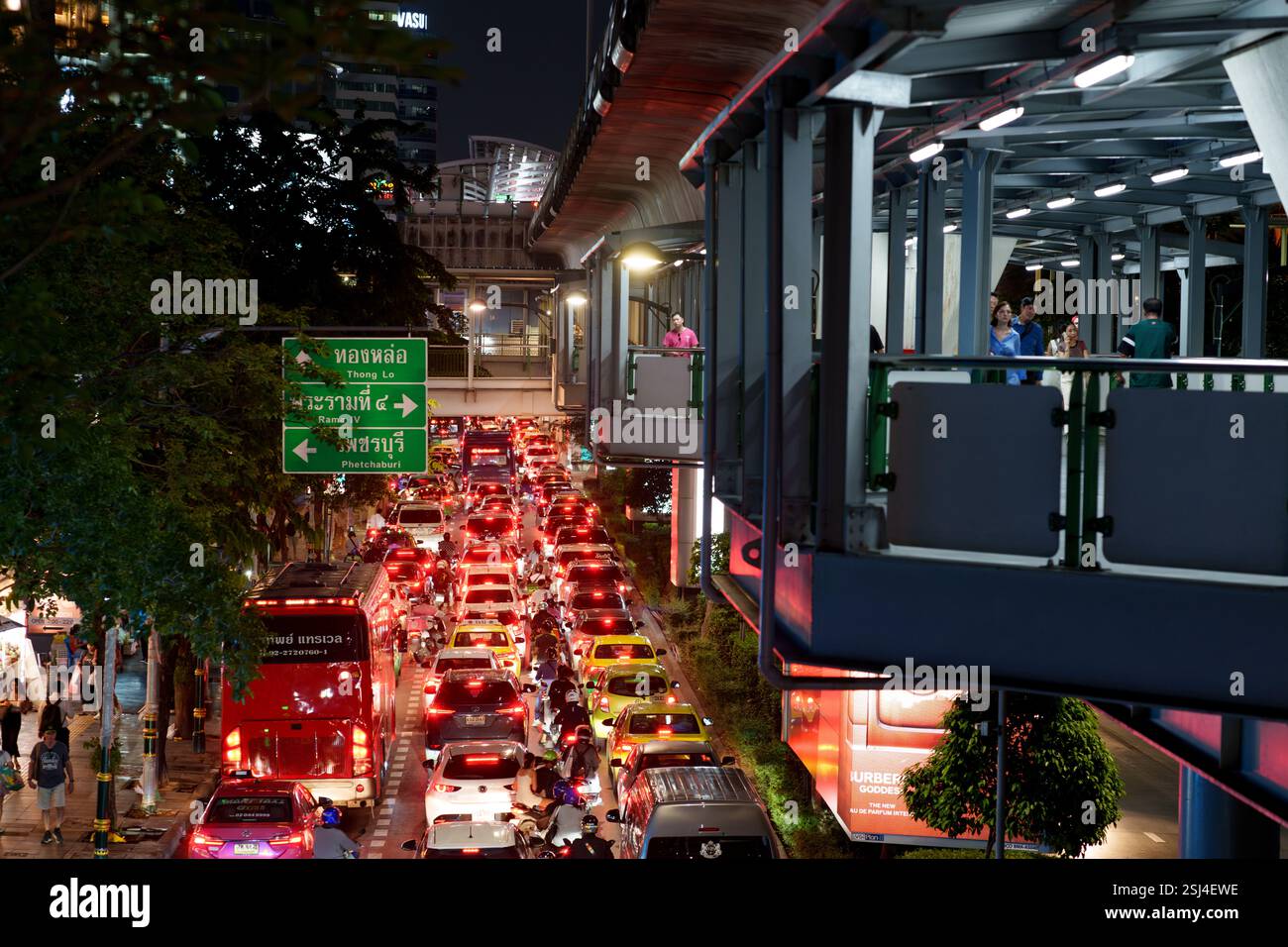 A bustling night scene on Sukhumvit Road in Bangkok captures the ...