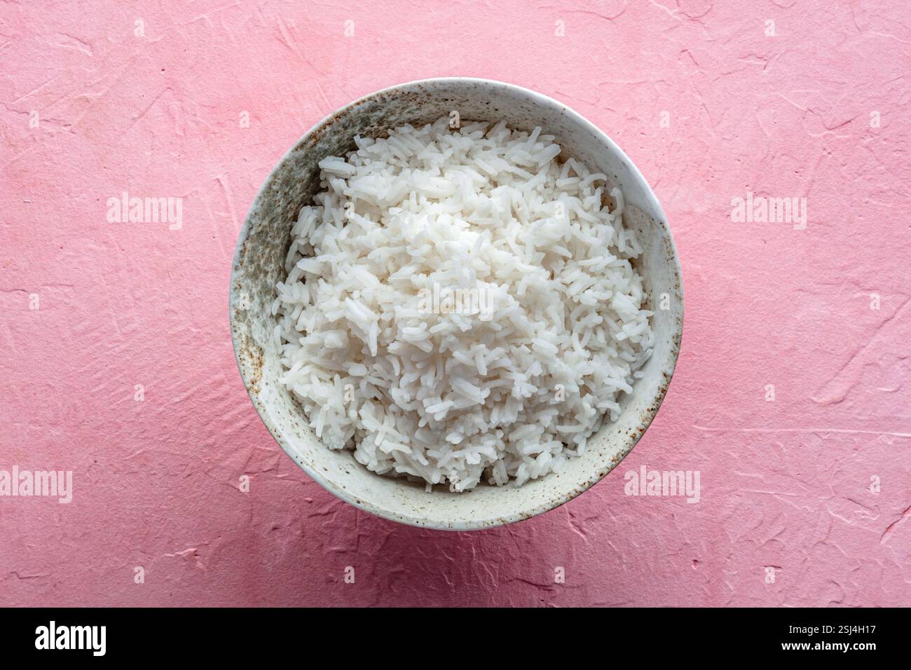 White rice, cooked. A bowl of boiled long grain rice, a simple side ...