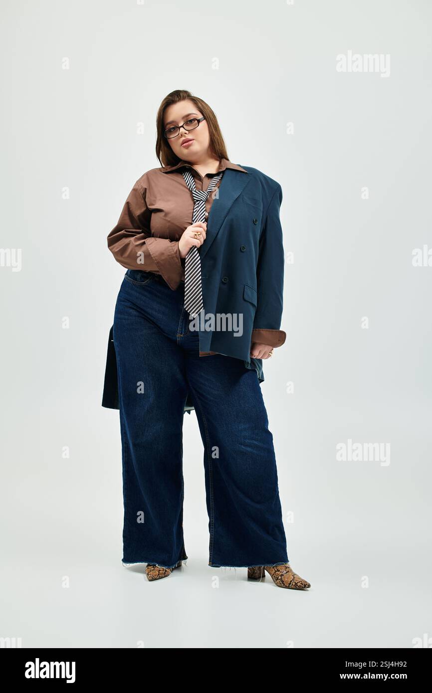 A young and beautiful plus size woman showcases an oversized outfit ...
