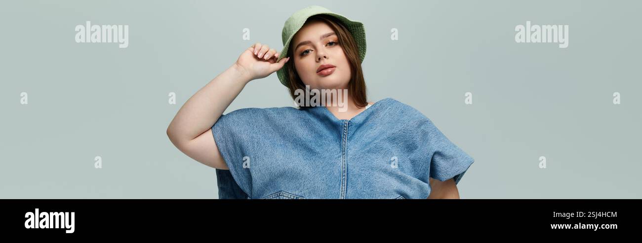 A young plus size woman poses confidently in a trendy denim ensemble ...