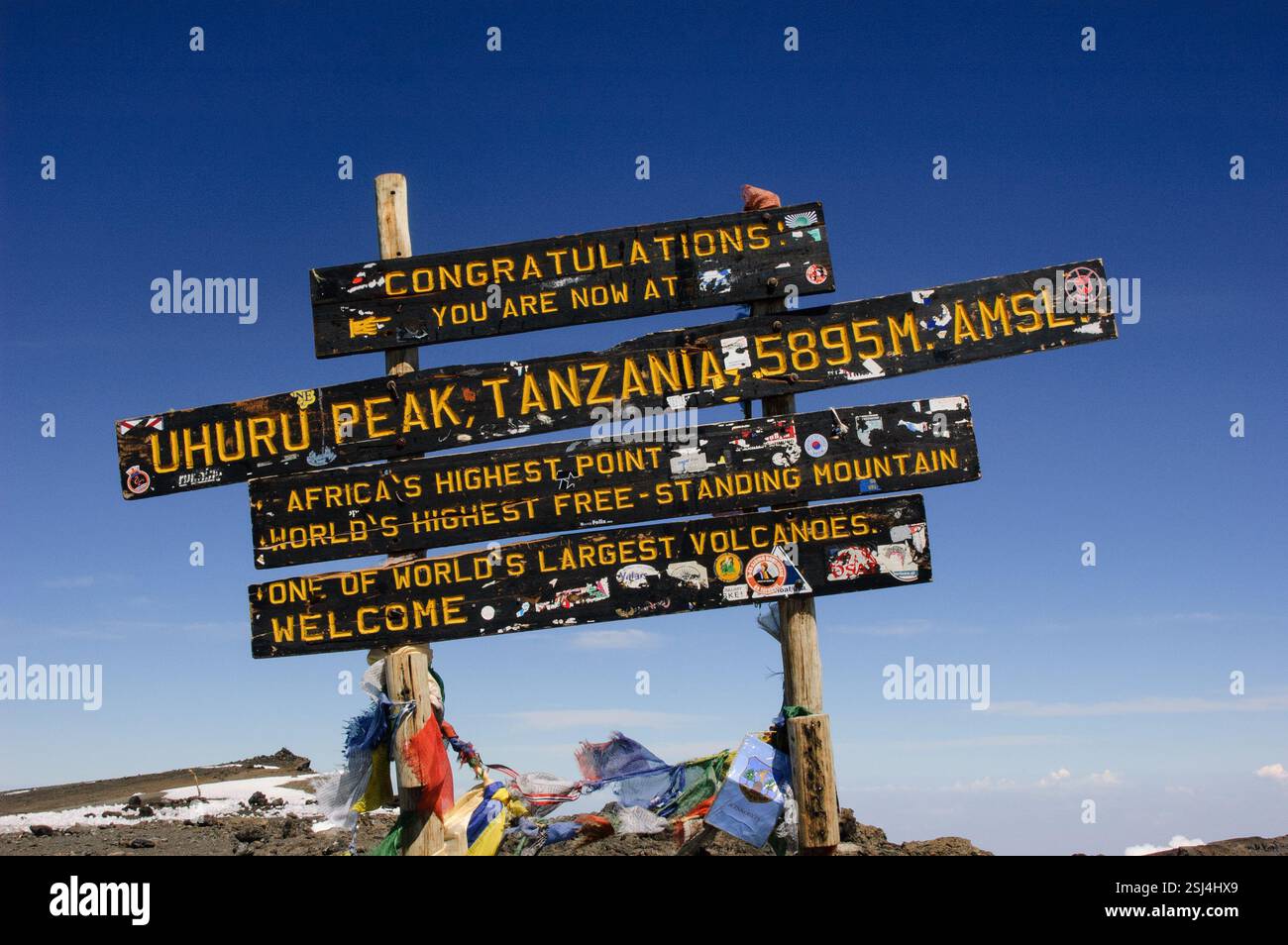 The summit sign atop Uhuru Peak, Tanzania, the top of Mt. Kilimanjaro, the highest elevation on ...