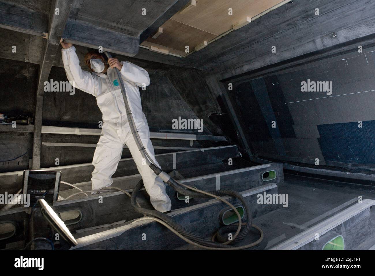 Shipbuilding Industry. Working on a glass fiber hull of a super sailing ...