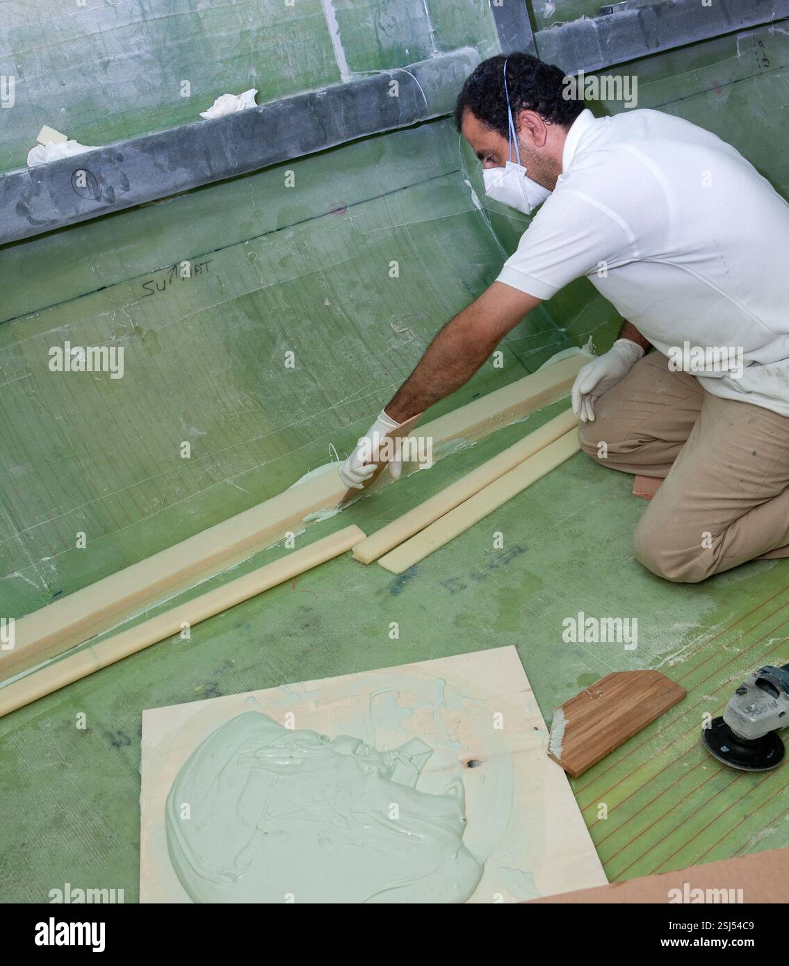 Shipbuilding Industry. Working on a glass fiber hull of a super sailing ...