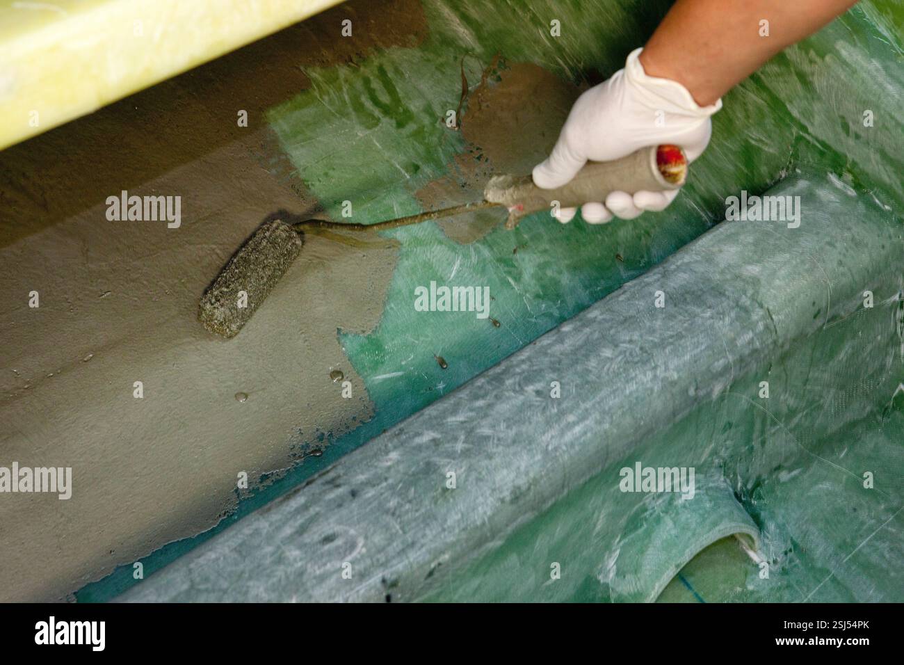 Shipbuilding Industry. Working on a glass fiber hull of a super sailing ...