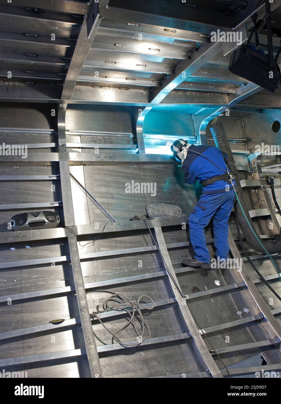 Welder at work welding aluminium. Shipbuilding Industry. Aluminium hull ...