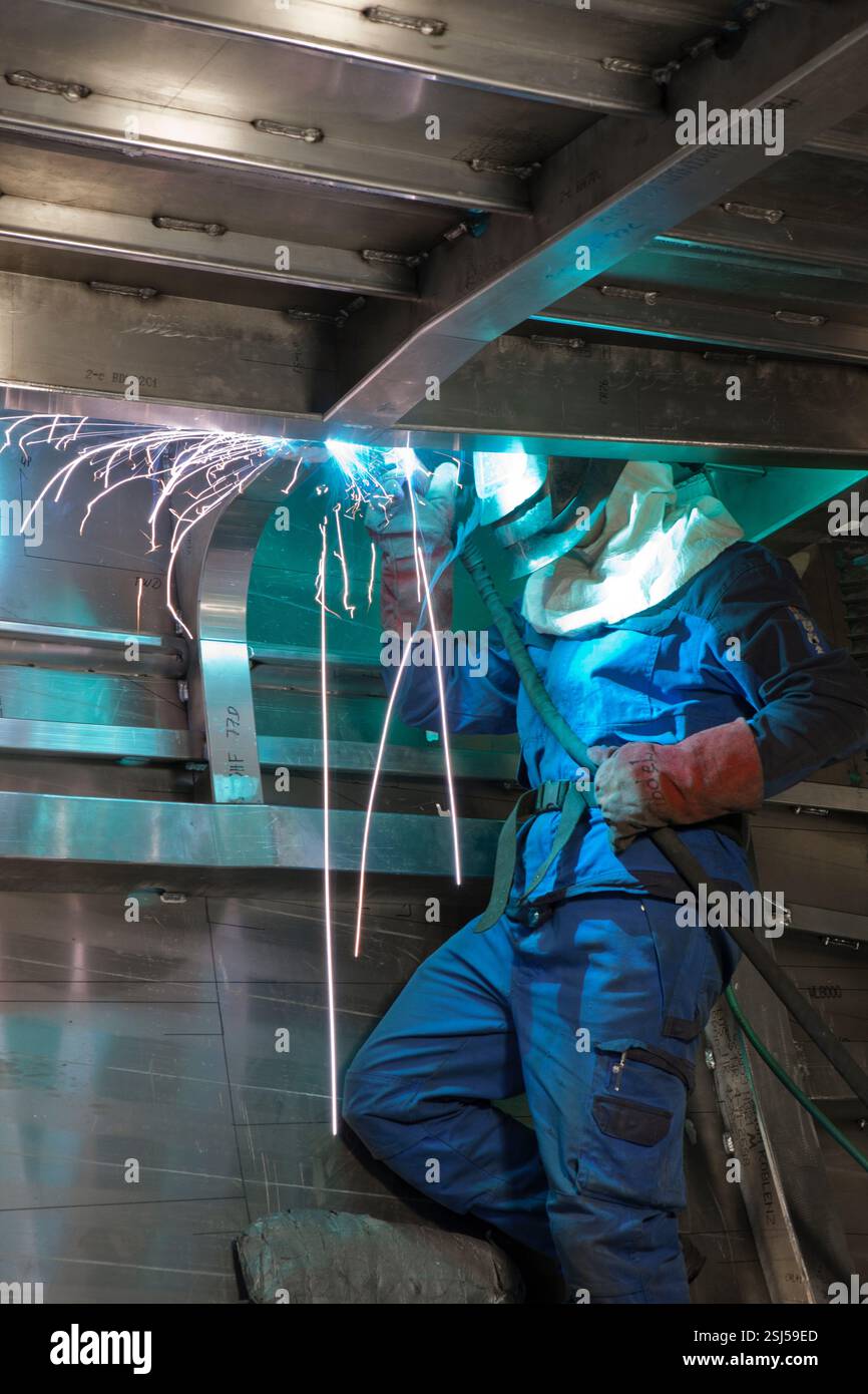 Welder at work welding aluminium. Shipbuilding Industry. Aluminium hull ...