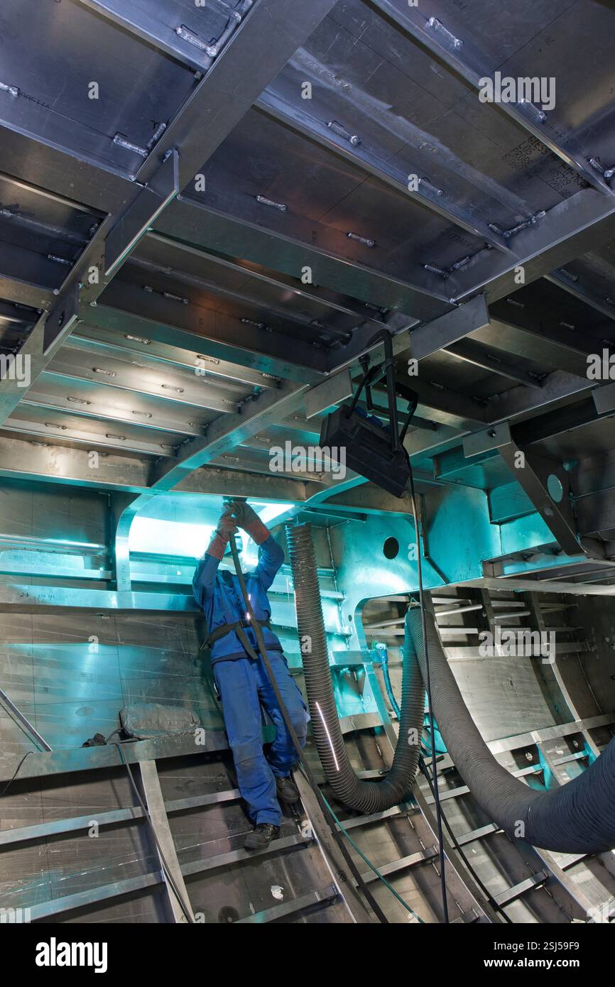 Welder at work welding aluminium. Shipbuilding Industry. Aluminium hull ...