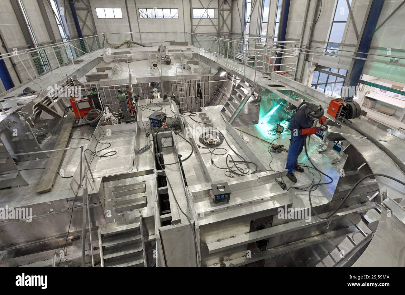 Welder at work welding aluminium. Shipbuilding Industry. Aluminium hull ...
