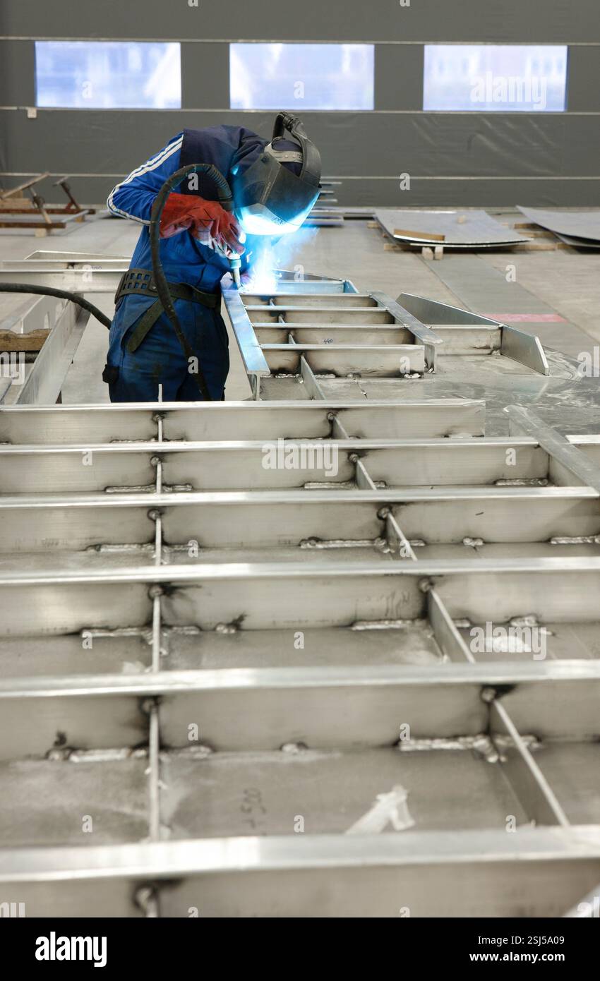 Welder at work welding aluminium. Shipbuilding Industry. Aluminium hull ...