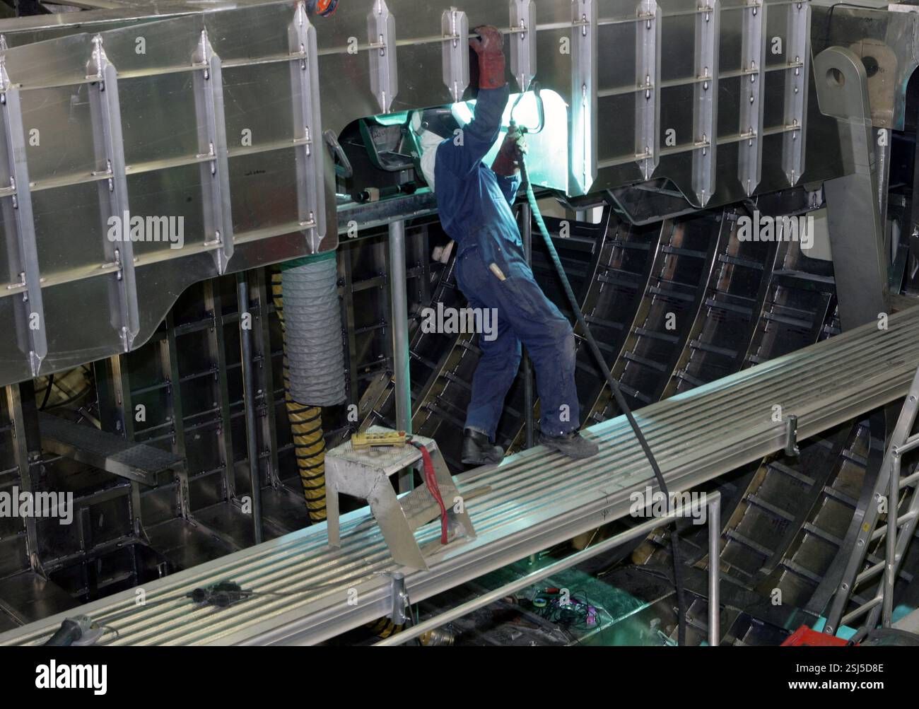 Welder at work welding aluminium. Shipbuilding Industry. Aluminium hull ...