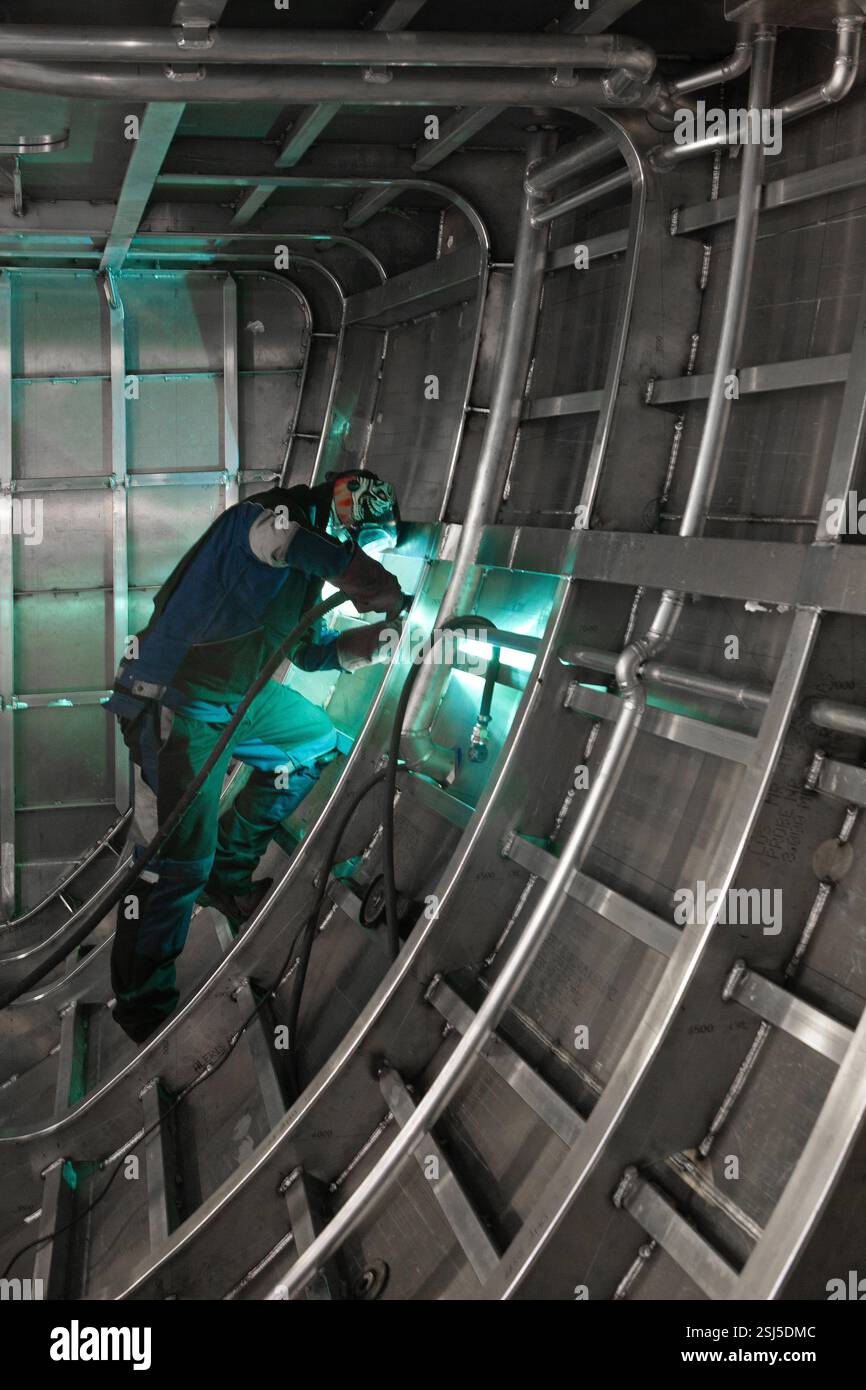 Welder at work welding aluminium. Shipbuilding Industry. Aluminium hull ...