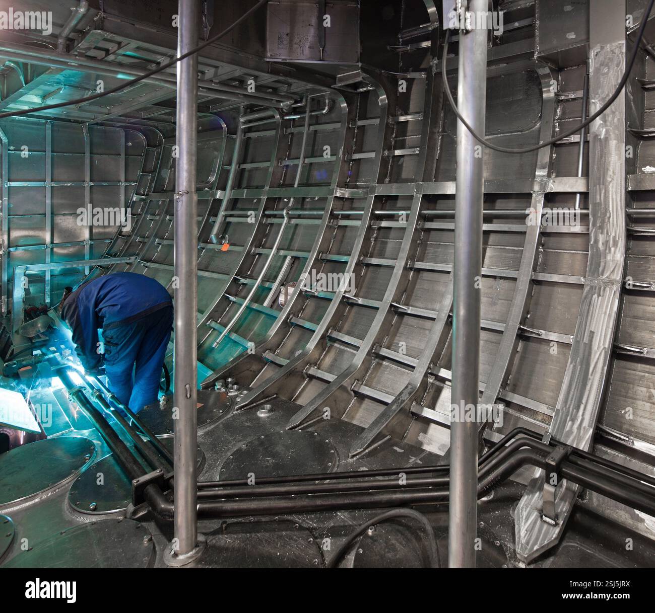 Welder at work welding aluminium. Shipbuilding Industry. Aluminium hull ...
