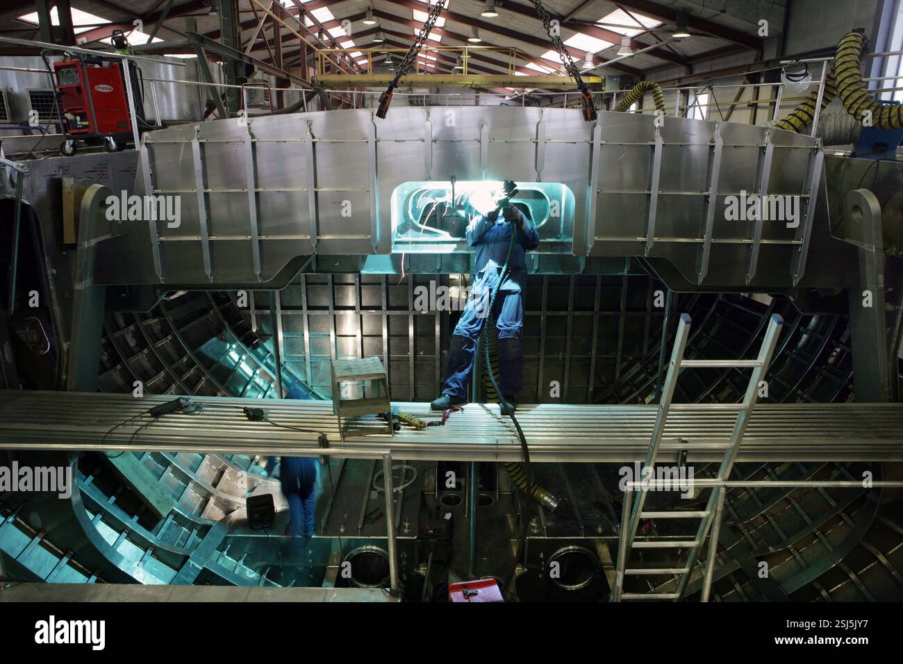 Welder at work welding aluminium. Shipbuilding Industry. Aluminium hull ...