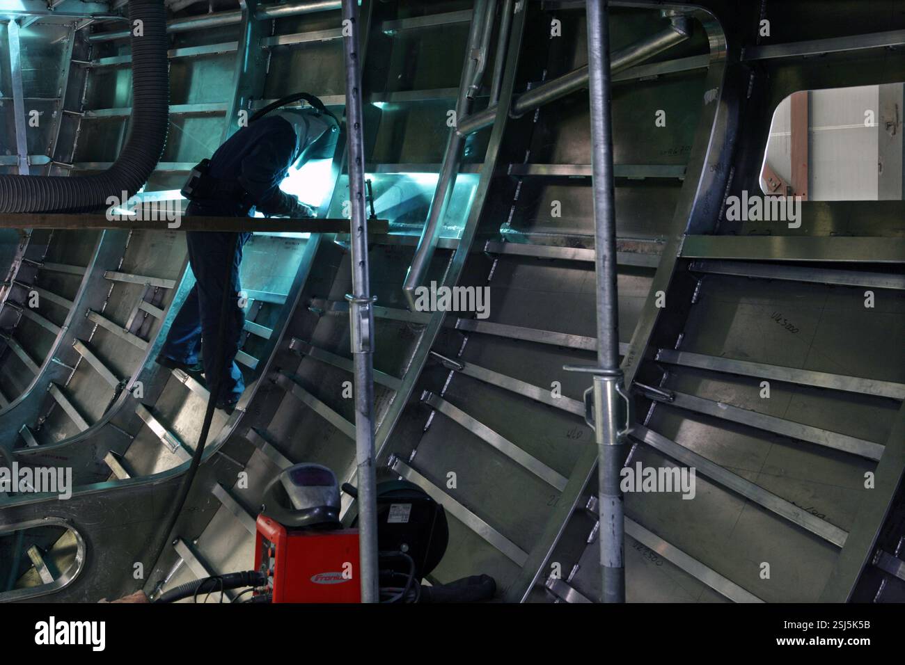 Welder at work welding aluminium. Shipbuilding Industry. Aluminium hull ...