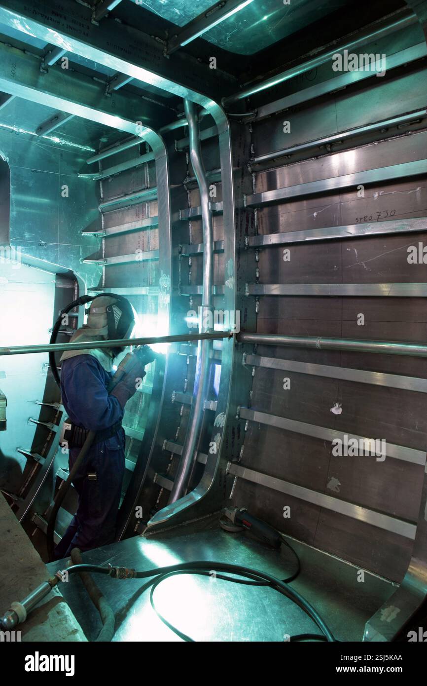 Welder at work welding aluminium. Shipbuilding Industry. Aluminium hull ...