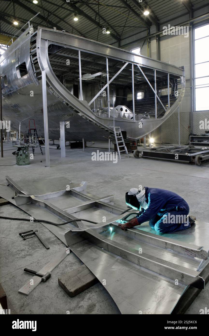 Welder at work welding aluminium. Shipbuilding Industry. Aluminium hull ...