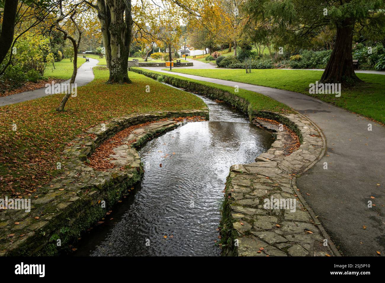 A small river stream flowing through the historic sub-tropical Trenance ...