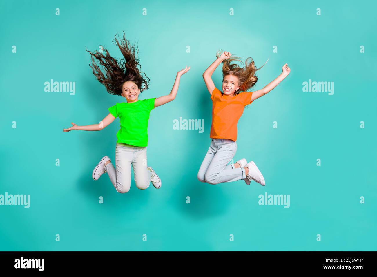 Full length body size photo of two jumping rejoicing overjoyed people ...