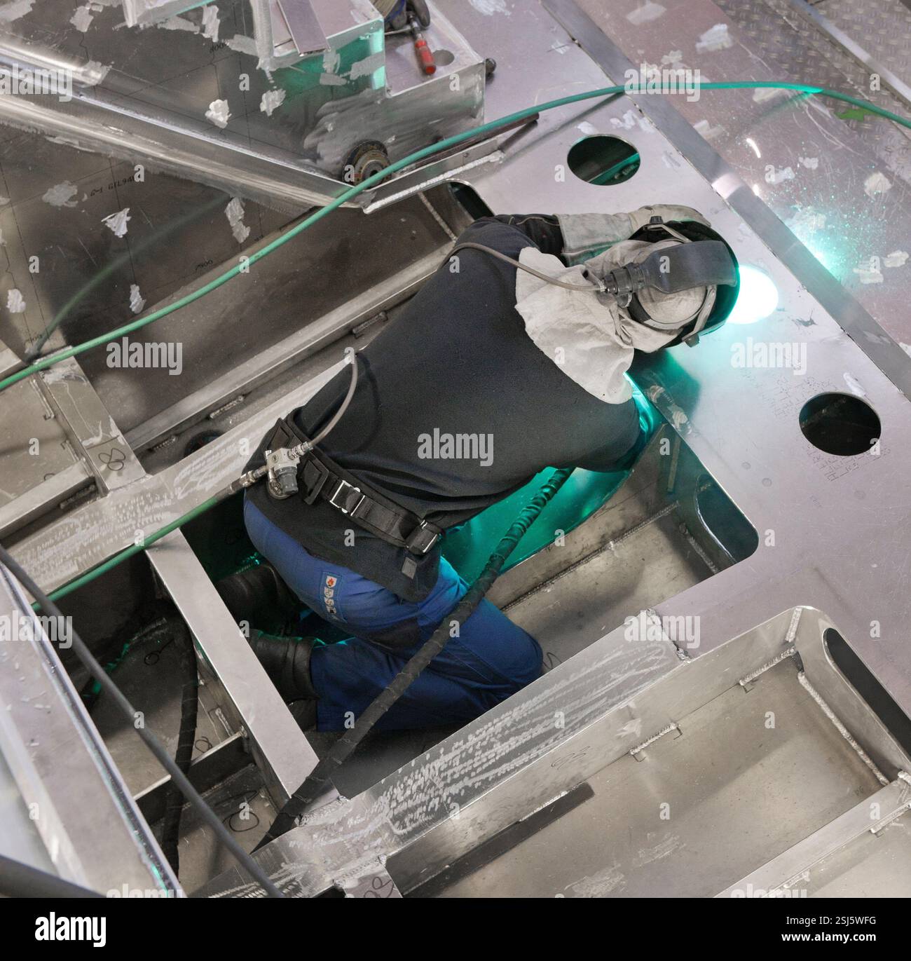 Welder at work welding aluminium. Shipbuilding Industry. Aluminium hull ...