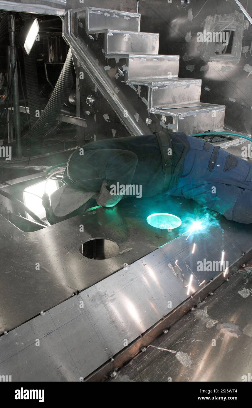 Welder at work welding aluminium. Shipbuilding Industry. Aluminium hull ...