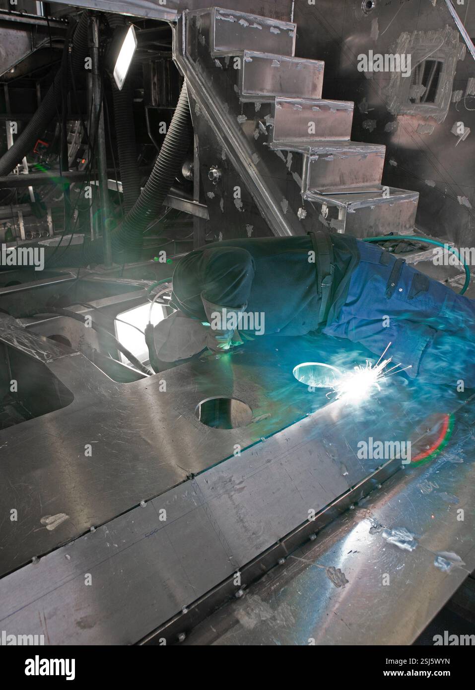 Welder at work welding aluminium. Shipbuilding Industry. Aluminium hull ...
