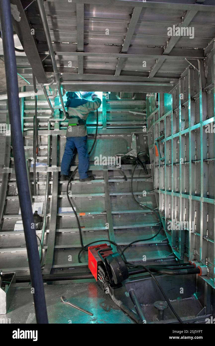 Welder at work welding aluminium. Shipbuilding Industry. Aluminium hull ...