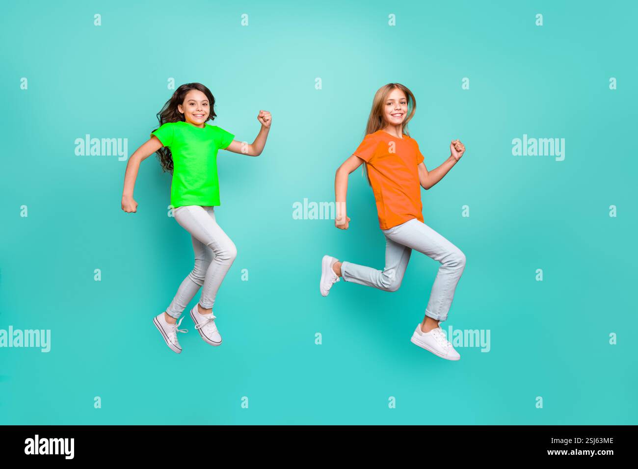 Full length body size photo of two cheerful people girls running ...