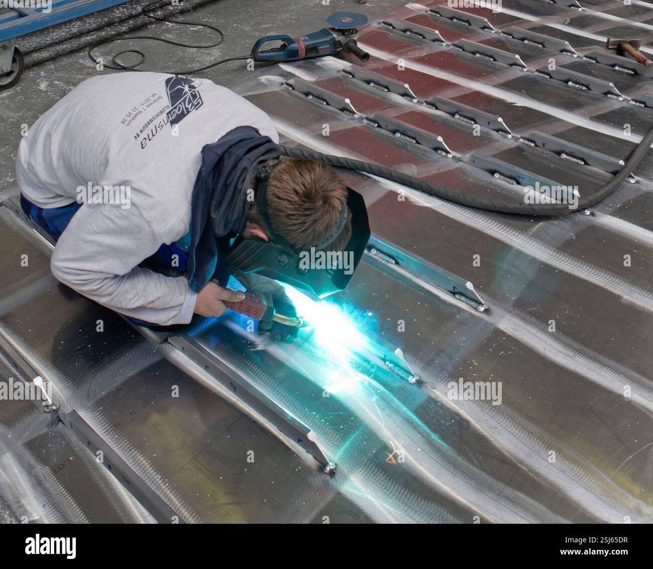 Welder at work welding aluminium. Shipbuilding Industry. Aluminium hull ...