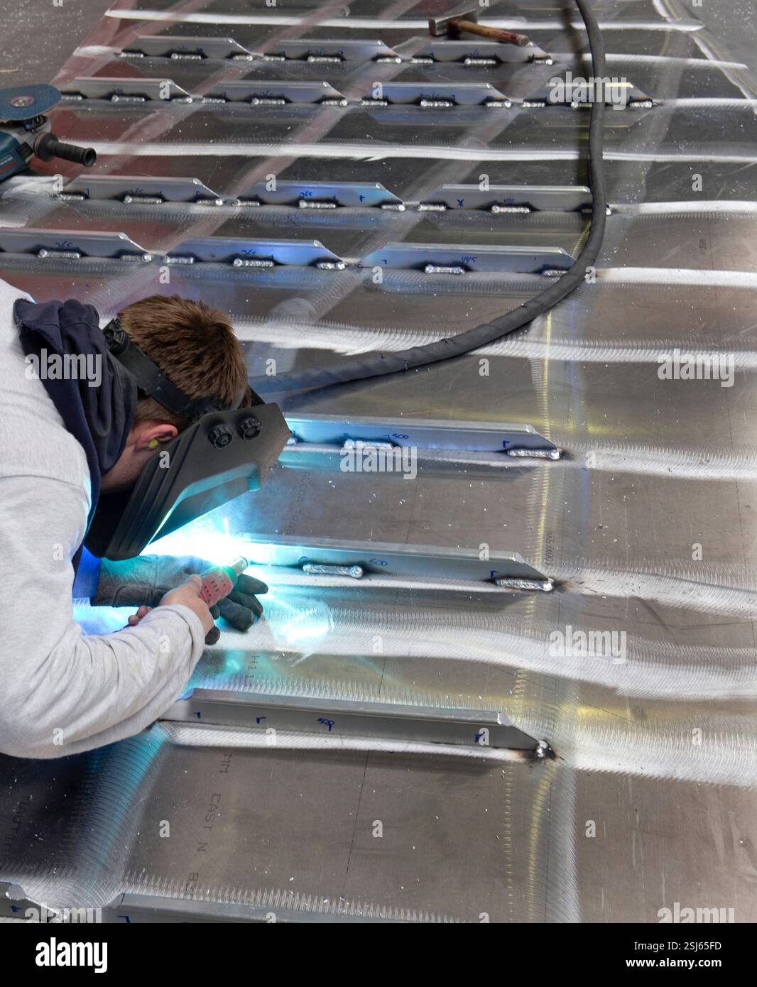 Welder at work welding aluminium. Shipbuilding Industry. Aluminium hull ...