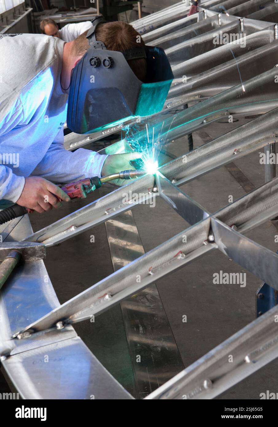 Welder at work welding aluminium. Shipbuilding Industry. Aluminium hull ...