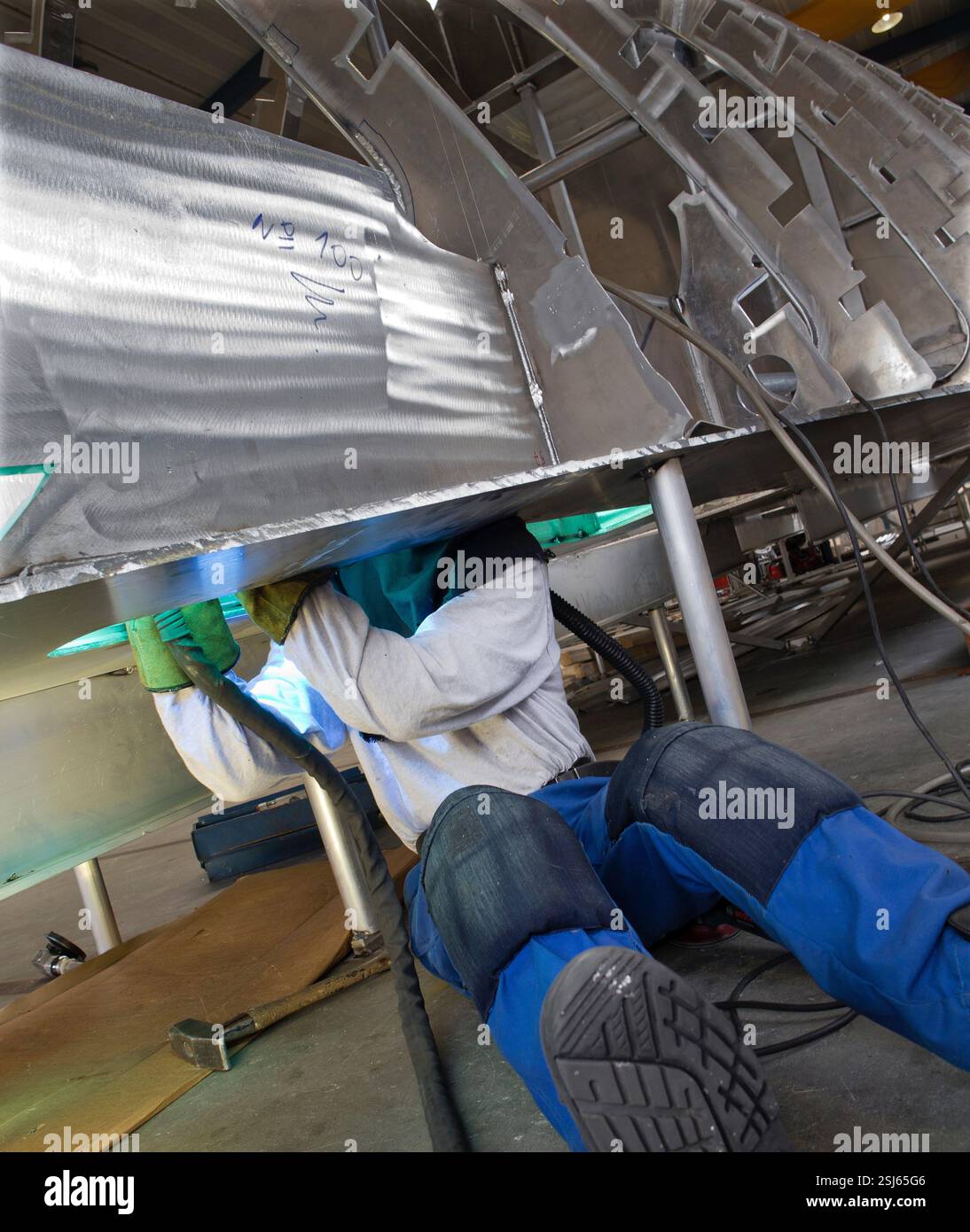 Welder at work welding aluminium. Shipbuilding Industry. Aluminium hull ...