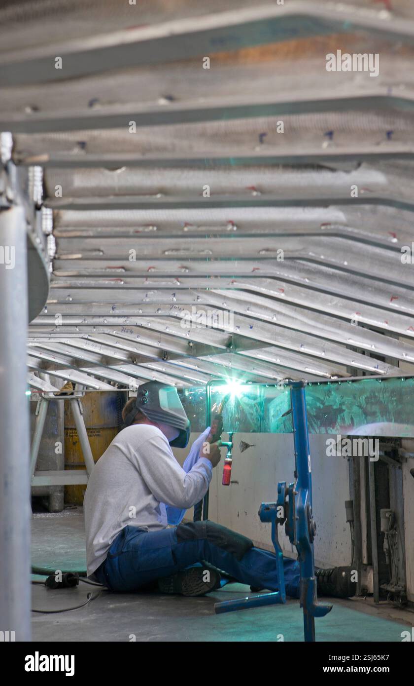 Welder at work welding aluminium. Shipbuilding Industry. Aluminium hull ...