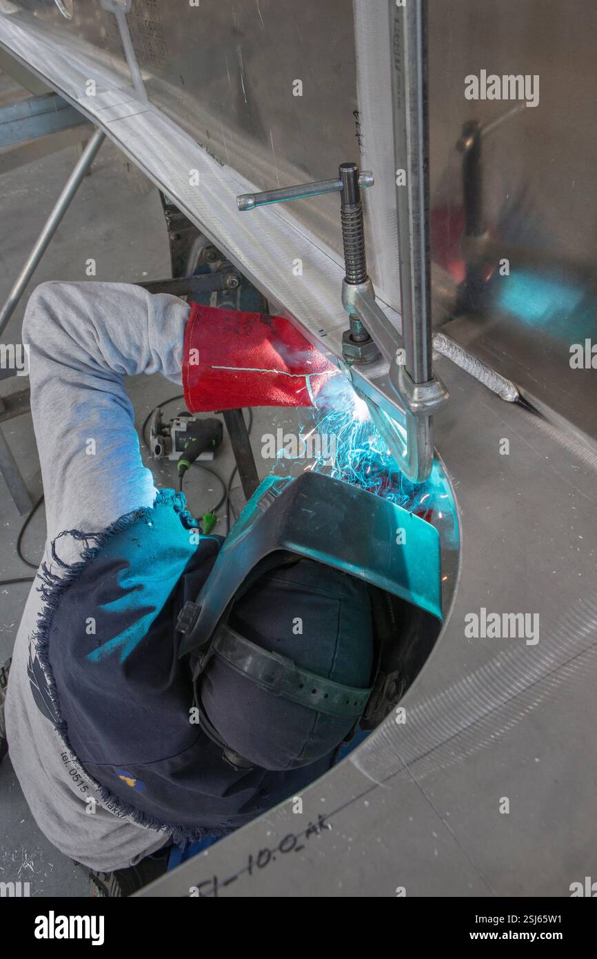 Welder at work welding aluminium. Shipbuilding Industry. Aluminium hull ...