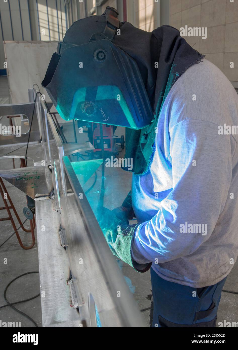 Welder at work welding aluminium. Shipbuilding Industry. Aluminium hull ...