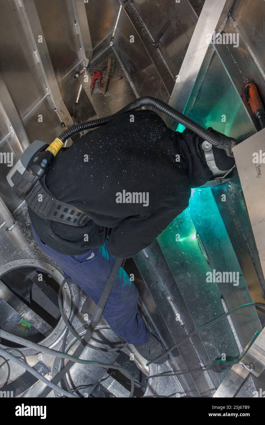Welder at work welding aluminium. Shipbuilding Industry. Aluminium hull ...