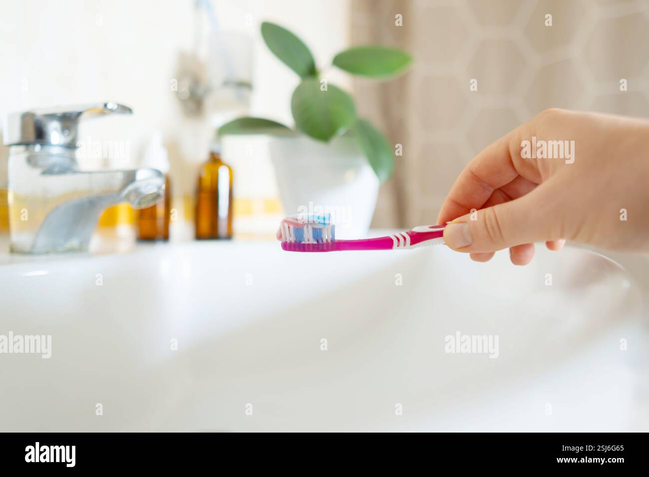 Brushing teeth before bed, woman holds a toothbrush and toothpaste ...