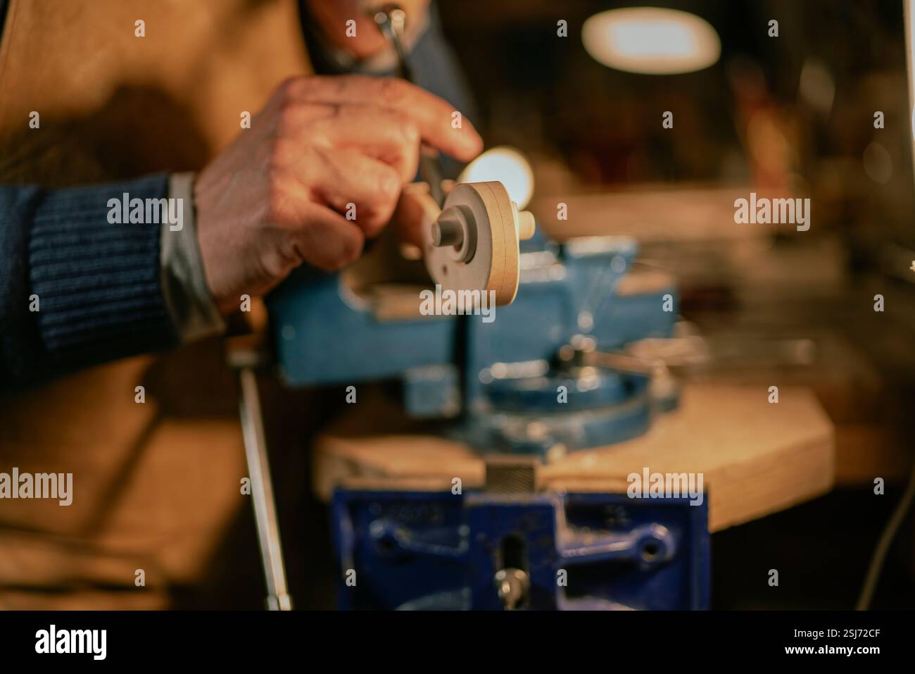 Italian luthier is carefully crafting the scroll of a violin, using ...