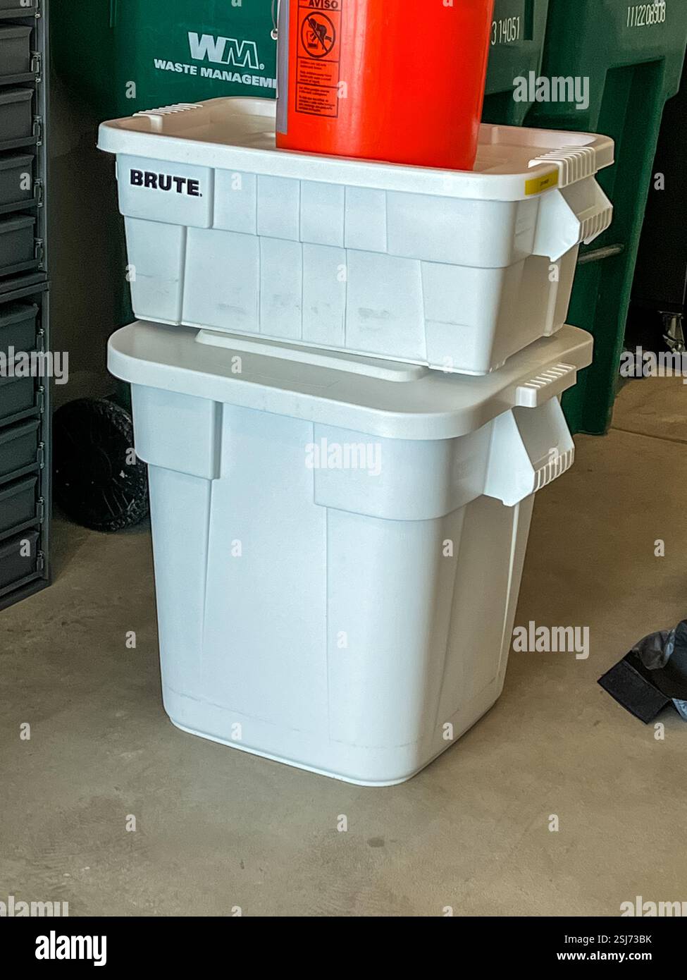 Stacked white Brute storage bins in garage Stock Photo - Alamy