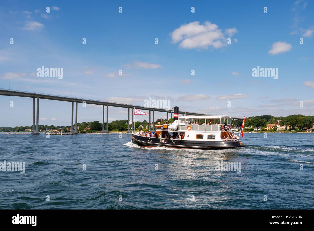 Traditional wooden passenger boat with tourists passing Svendborgsund ...