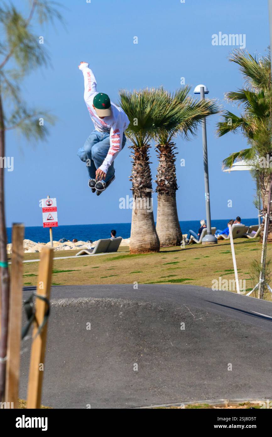 Urban extreme sport park. Young skateboarder performs stunts with a ...