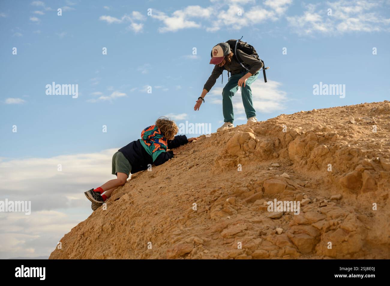 A helping hand concept a boy is reaching out his hand to help his ...