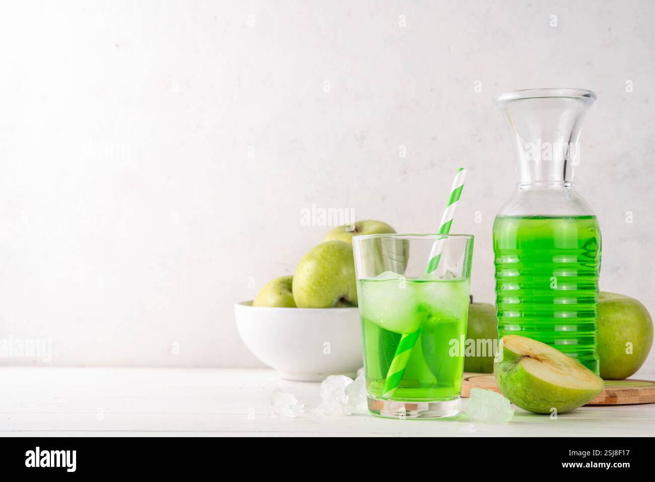 Homemade green apple lemonade cocktail, refreshing summer emerald color drink with fresh green ...